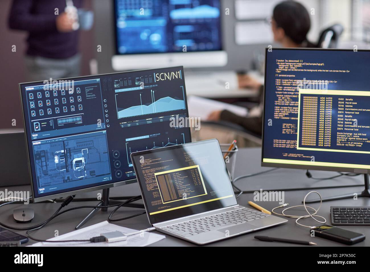 Background image of multiple computer screens with data and code on ...