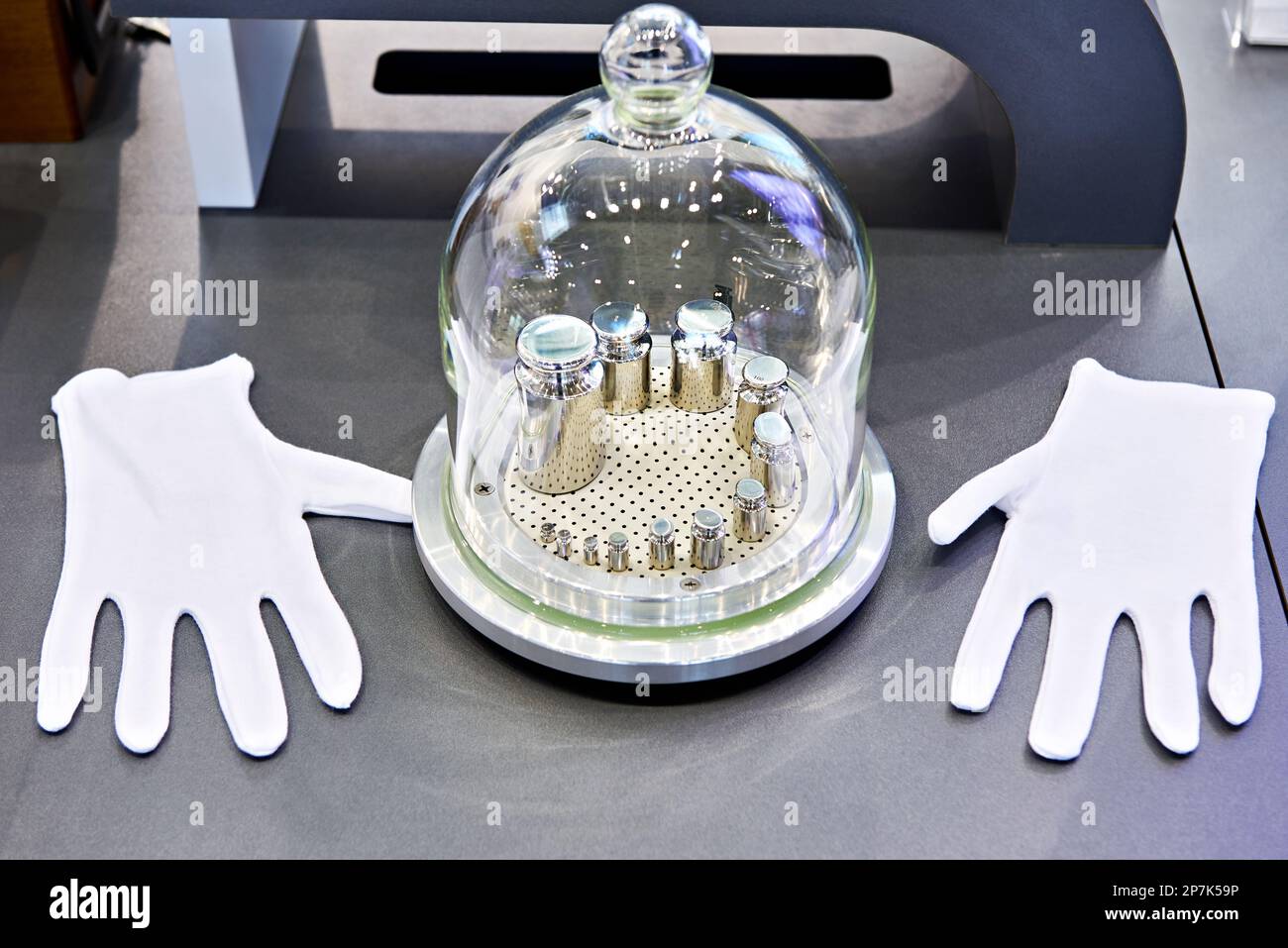 Gloves and weights for scales under a glass cover Stock Photo - Alamy