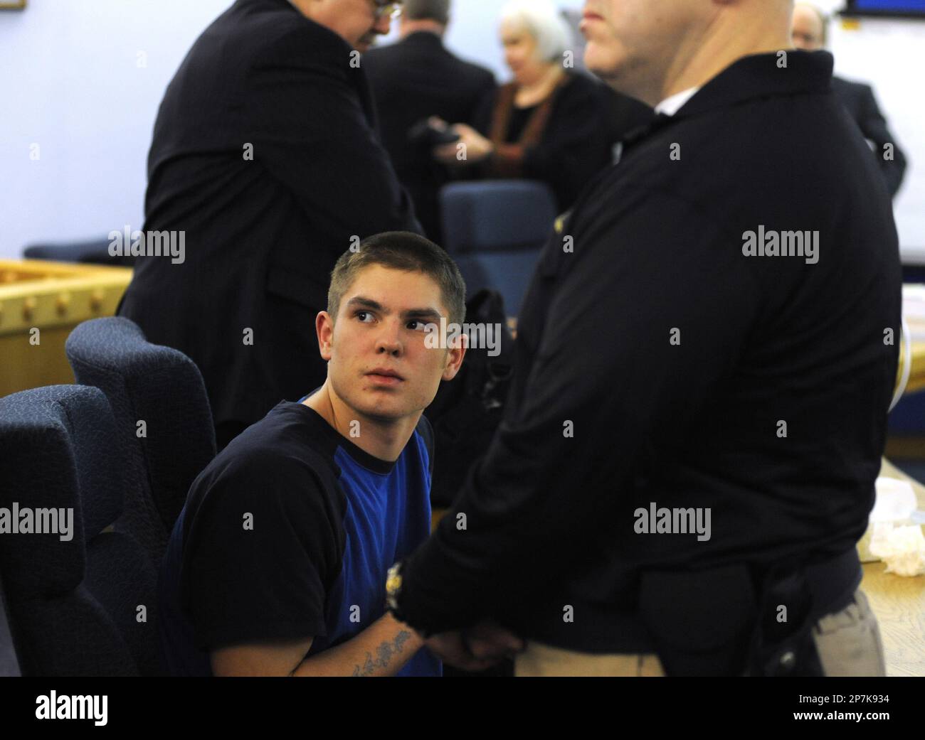 Jason Abbott, 20, watches his family leave the courthouse following his ...