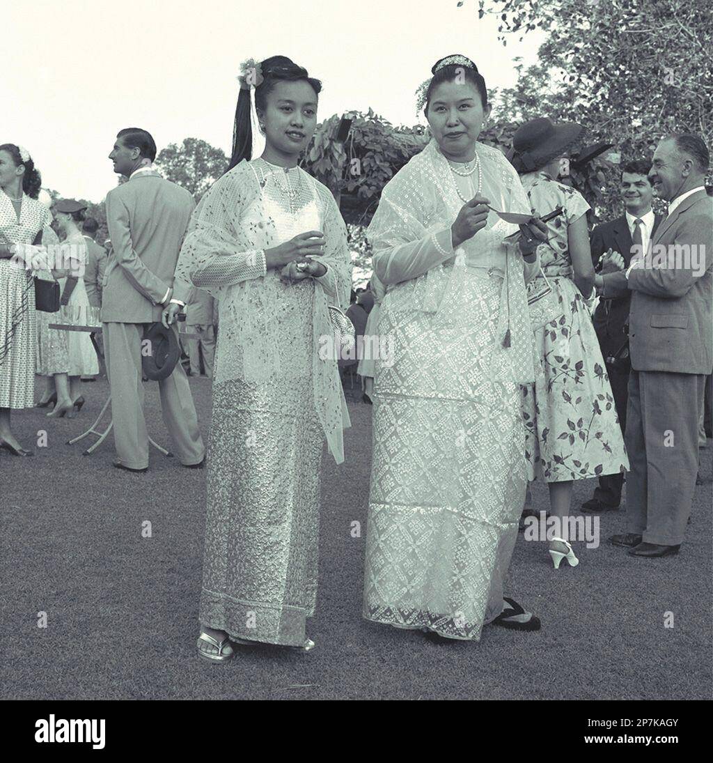 Mrs Myat Kyaw (left) wife of the Burmese Consul in Singapore, wears her ...