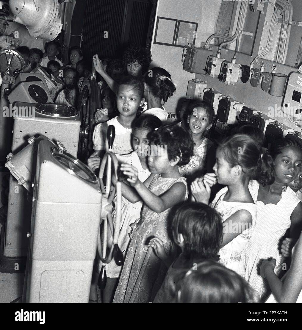 Eight-year-old Lim Ah Moy trying her skill in the Radar Room while her ...
