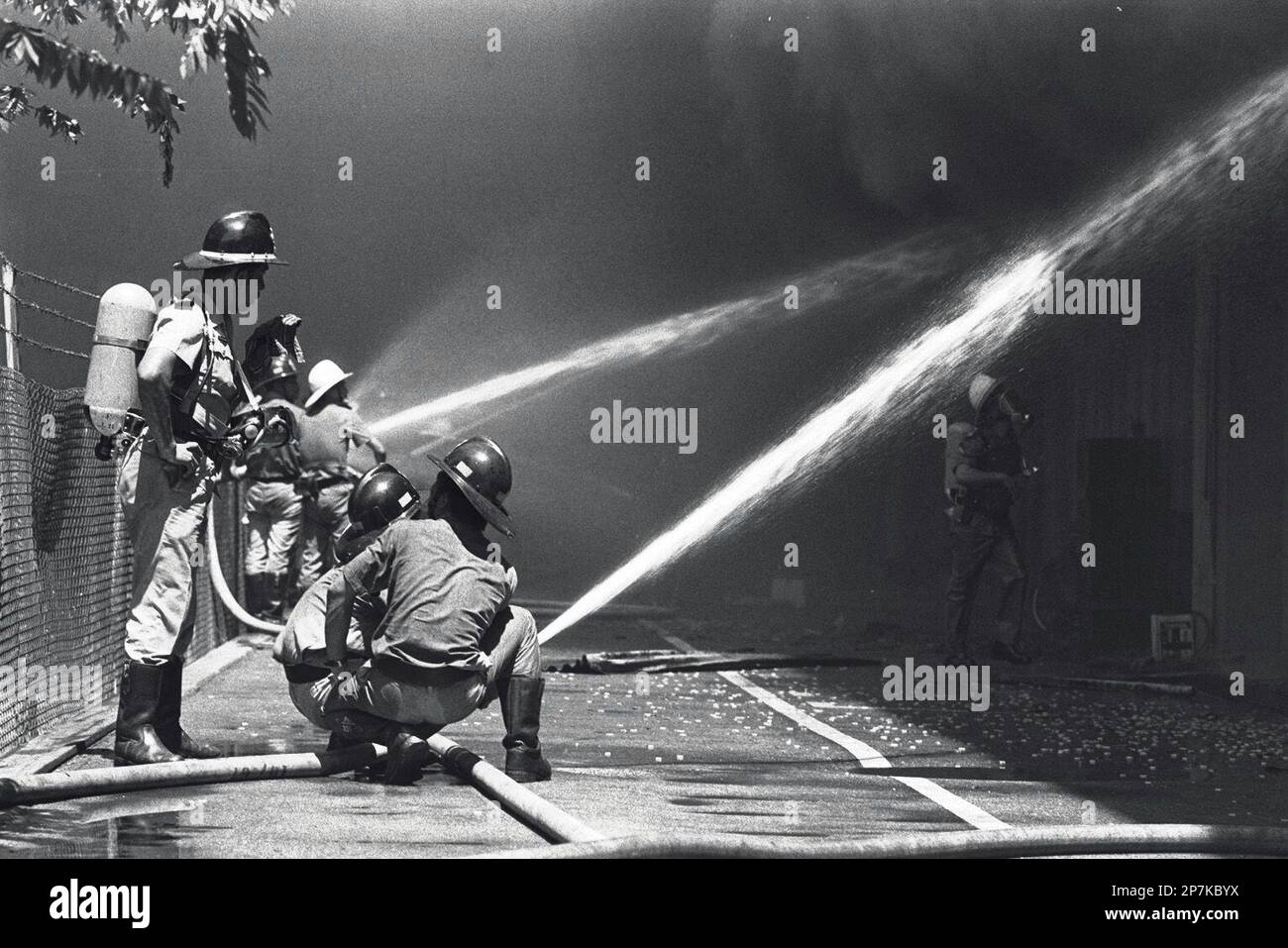 Firemen hosing water into the flaming Lum Tong Building at Pasir ...