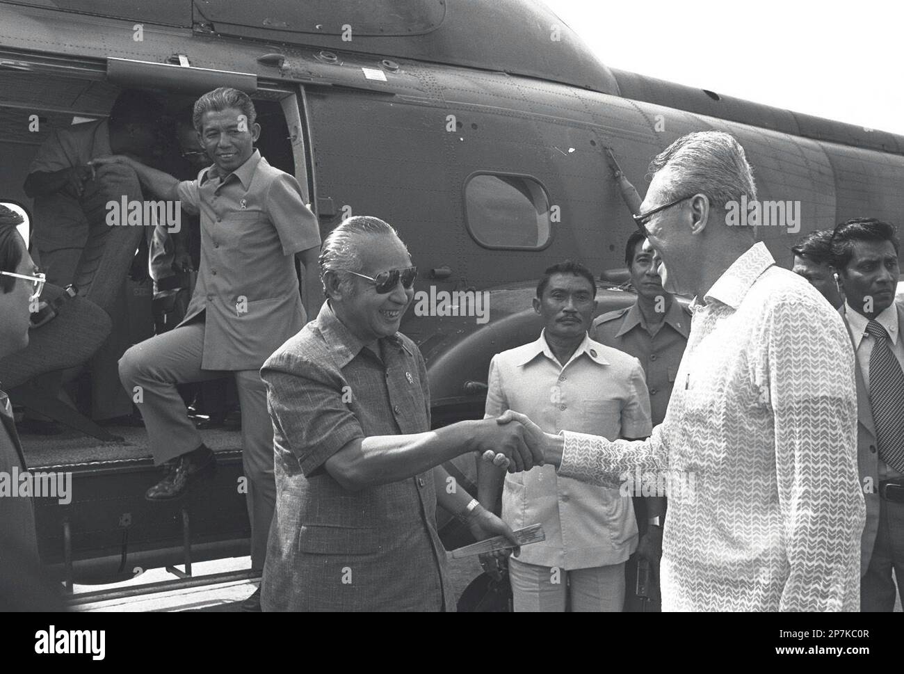 A beaming Indonesia President Suharto (second from left) being greeted ...