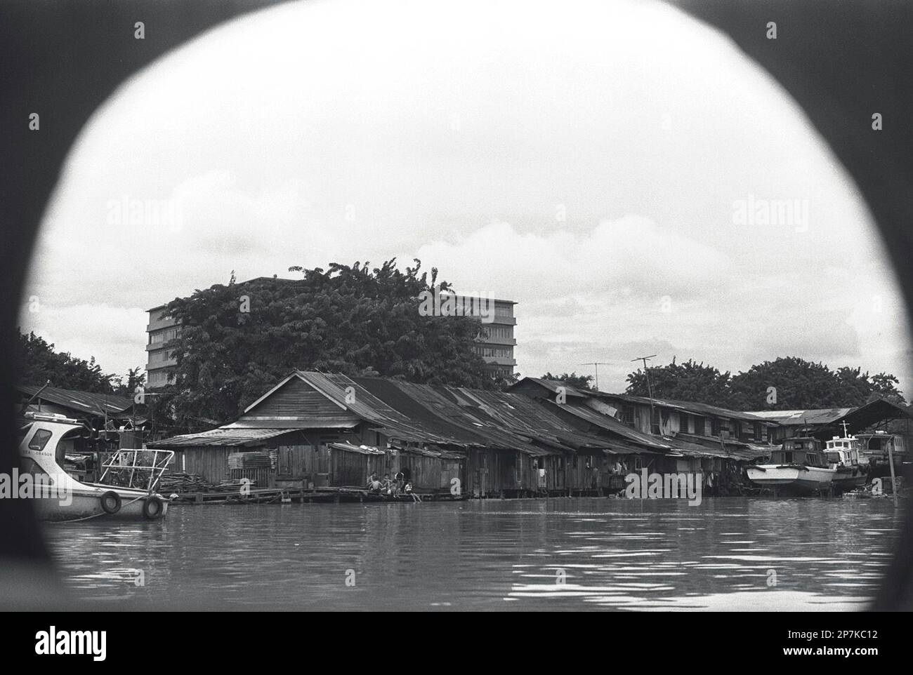 Clusters of huts along the banks of the Kallang River. A scene which ...