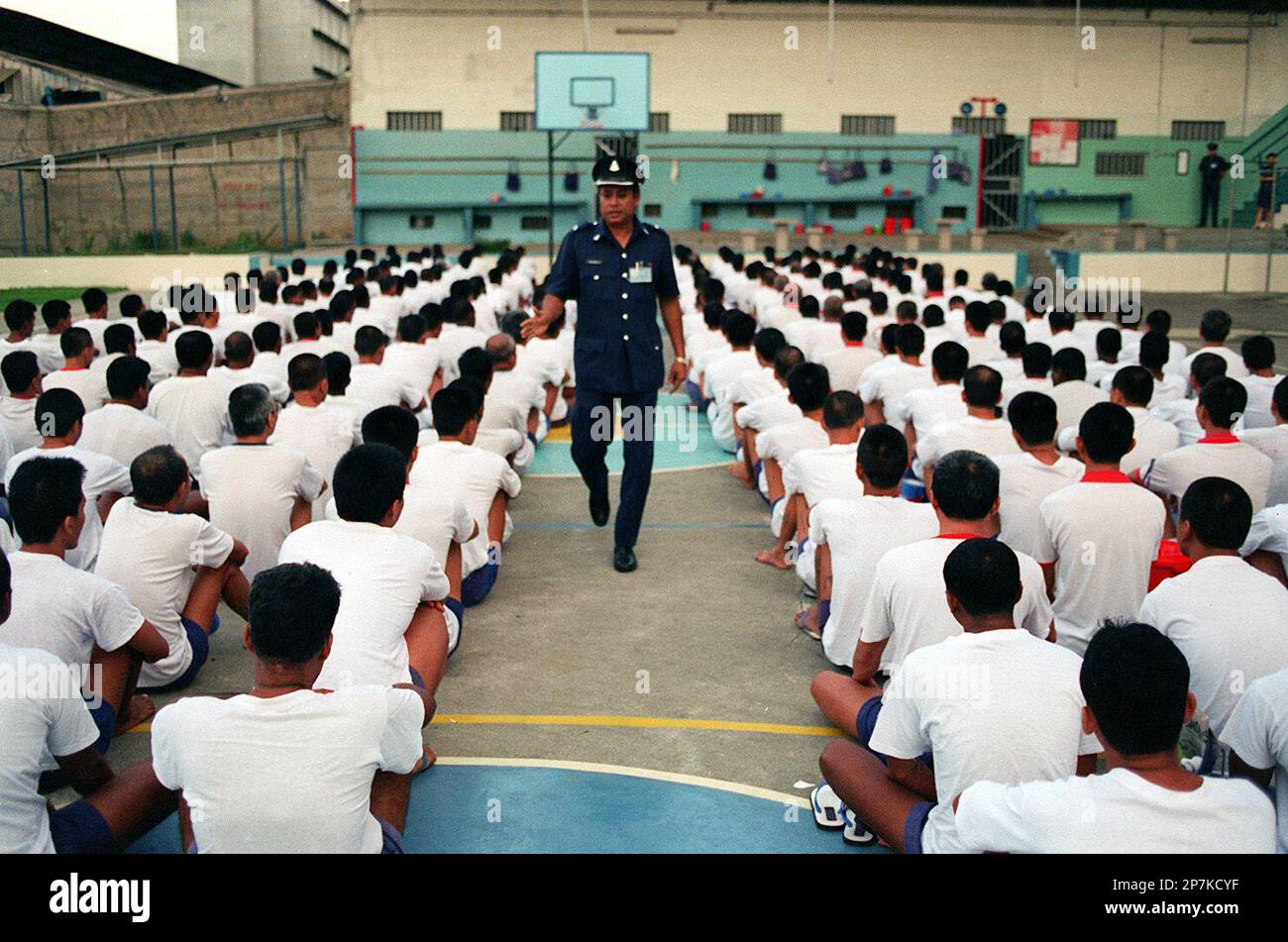 Prison officer and prisoners at Changi Prison.(Singapore Press via AP ...