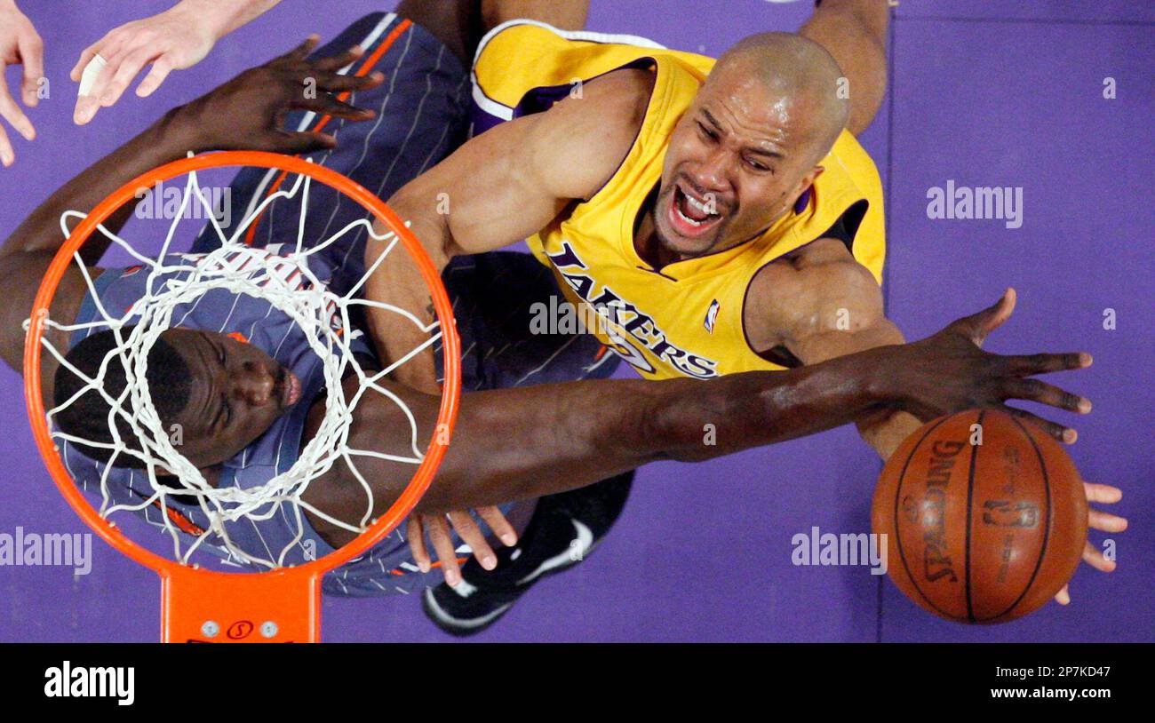 Los Angeles Lakers guard Derek Fisher, right, goes up for a shot as ...