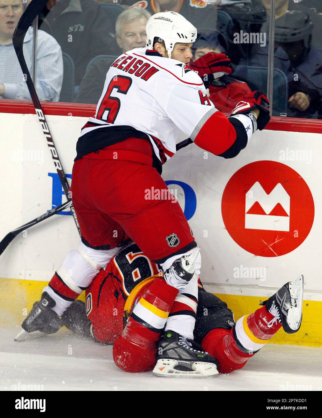 Carolina Hurricanes' Tim Gleason, top, checks Calgary Flames' Mikael ...