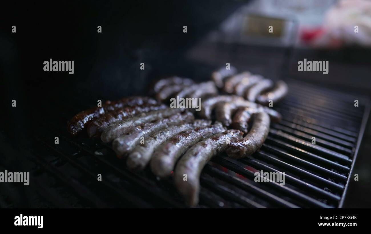 Revealing BBQ food on grill. Opening grill showing sausages cooking ...