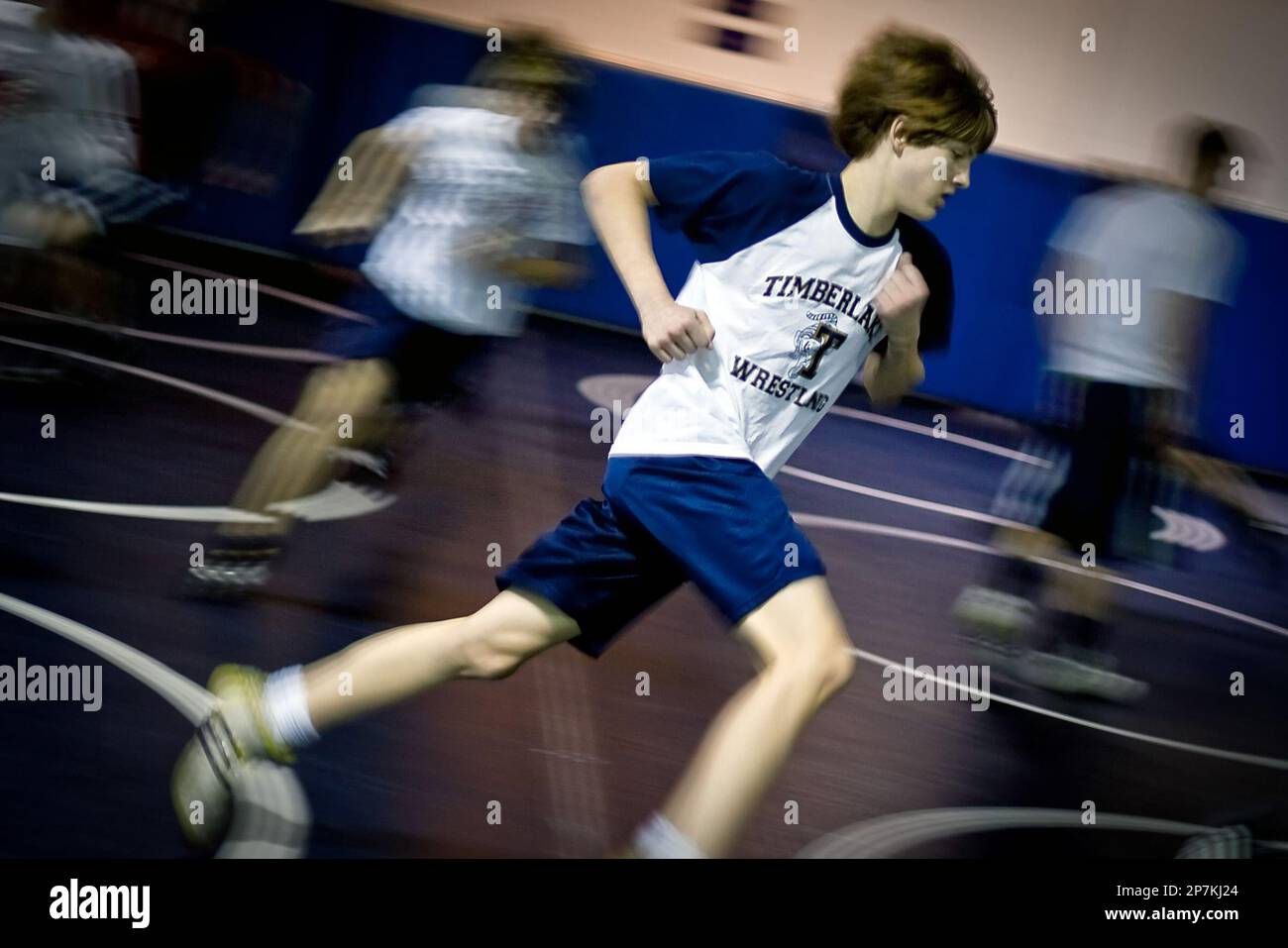 Dylan Kalar, 15, warms up by running laps around the gym with his ...
