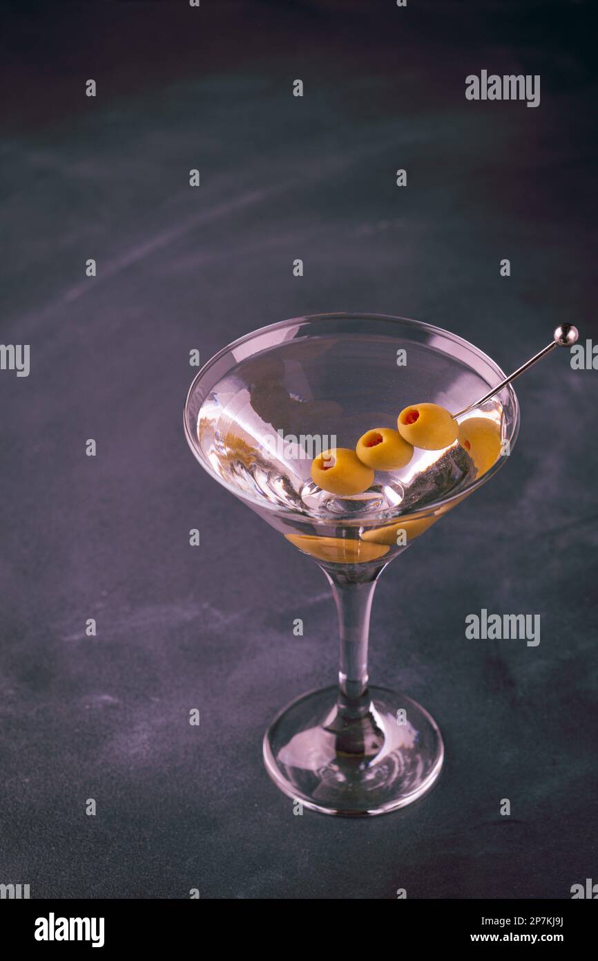 Classic Dry Martini with olives on dark stone table Stock Photo - Alamy