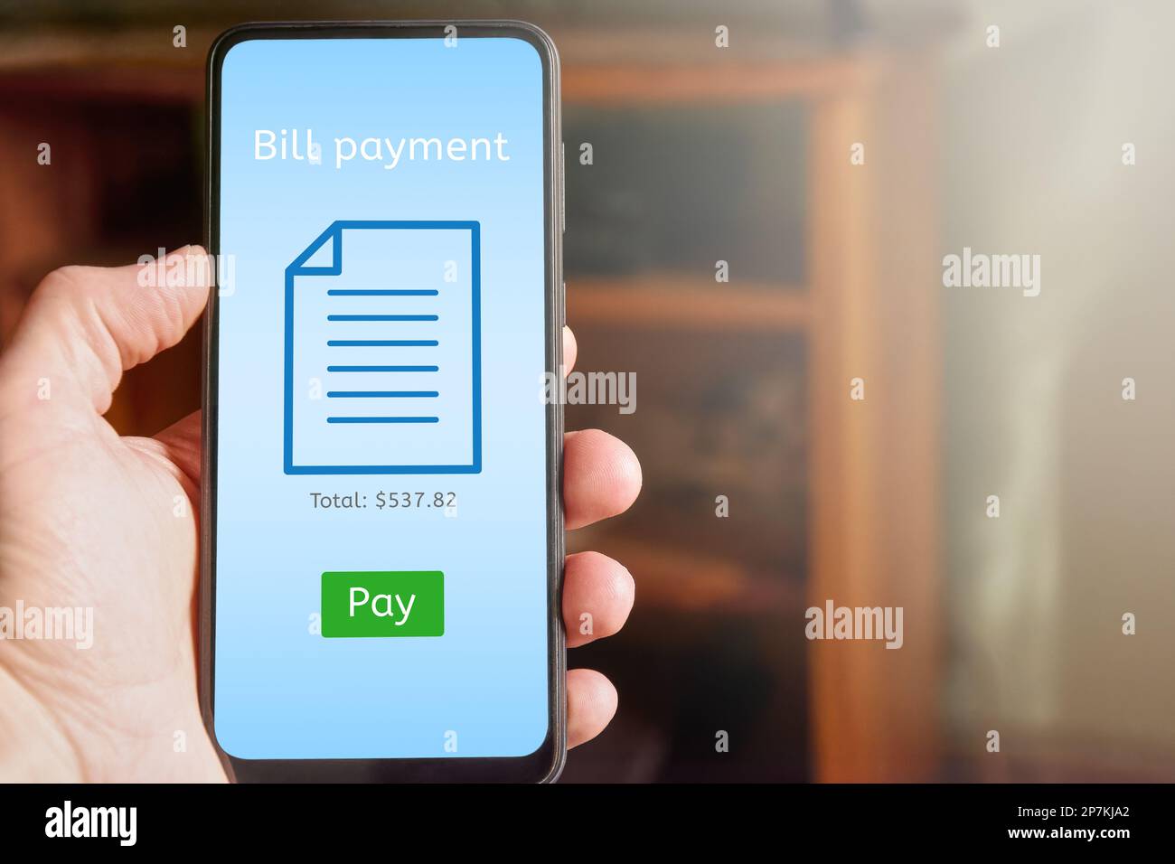Close up of hand holding mobile phone with online bill payment app ...