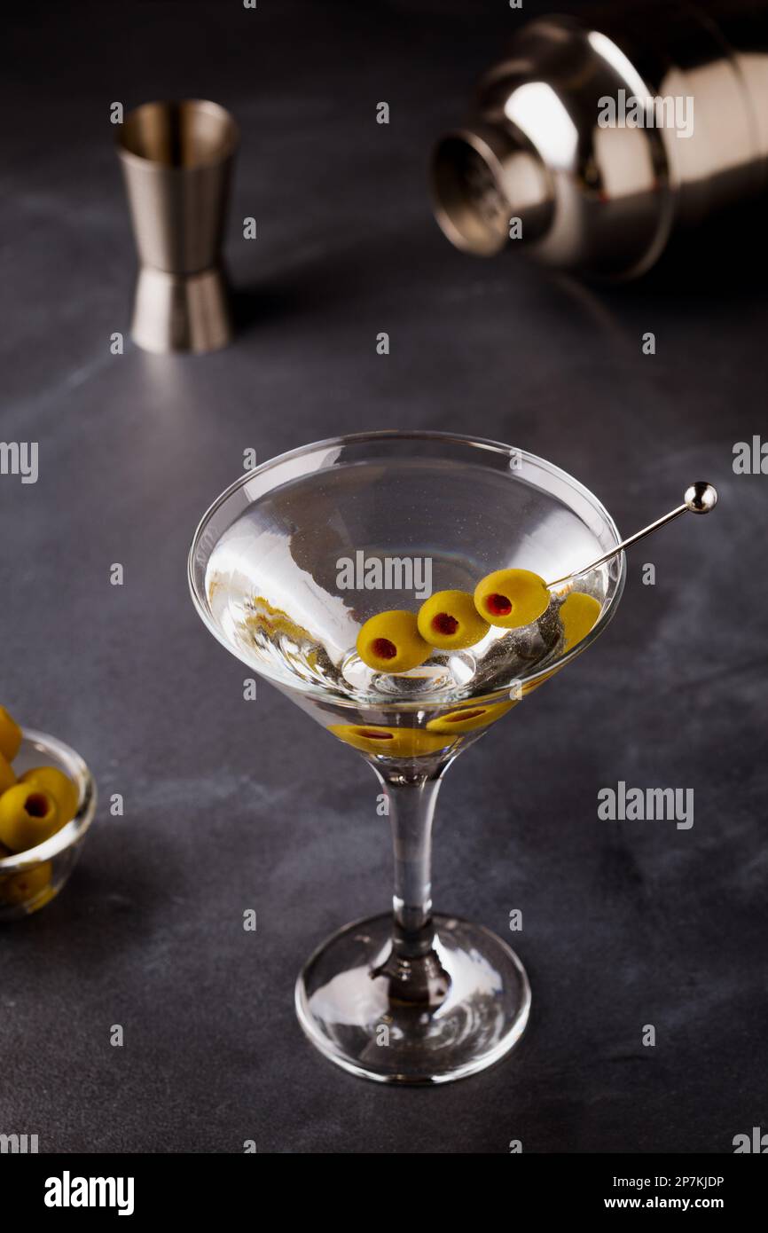 Classic Dry Martini with olives on dark stone table Stock Photo - Alamy