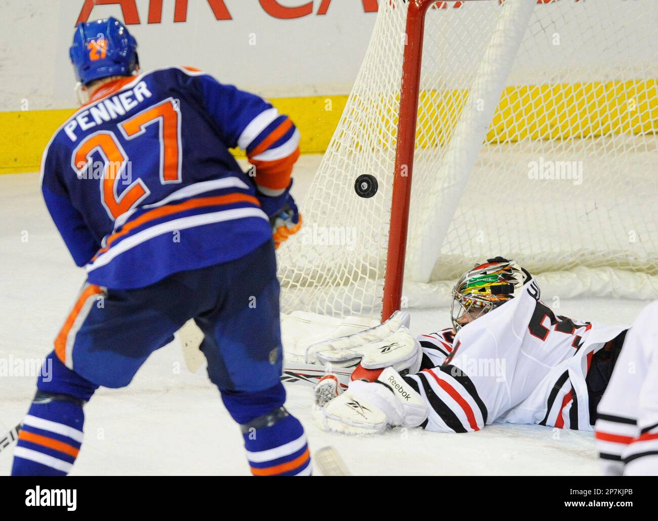 Edmonton Oilers' Dustin Penner, left, hits the pipe on the net of the ...