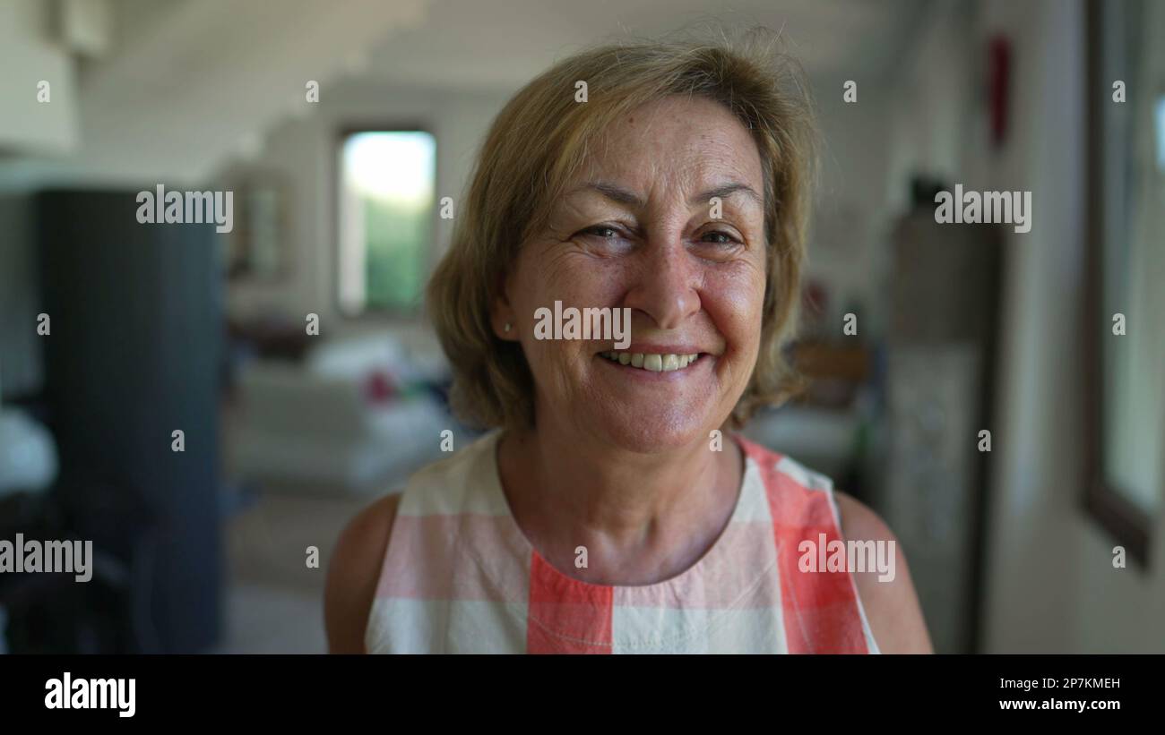 Portrait of a happy senior woman standing indoors at home. Close up ... Portrait of a happy senior woman standing indoors at home. Close up ...