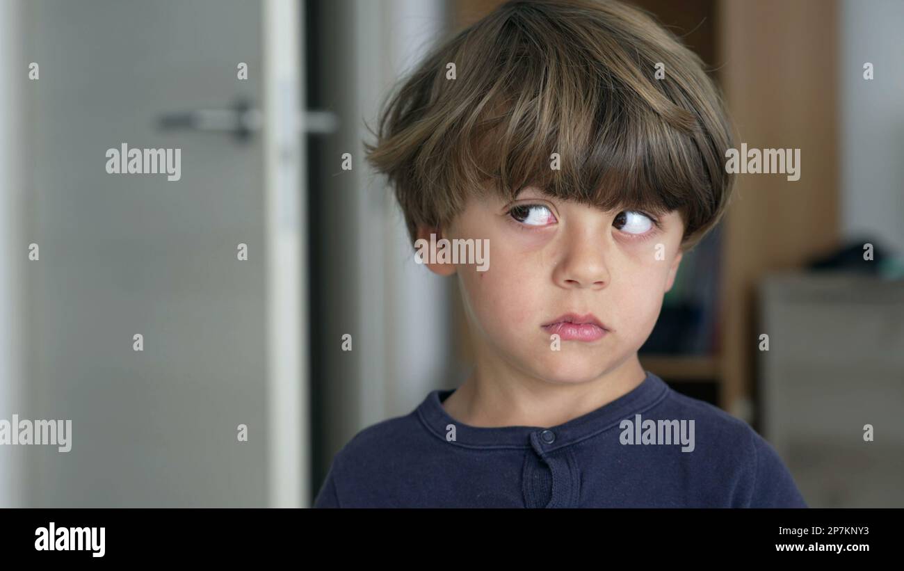 Portrait of one pensive young boy looking sideways thinking. Close up ...