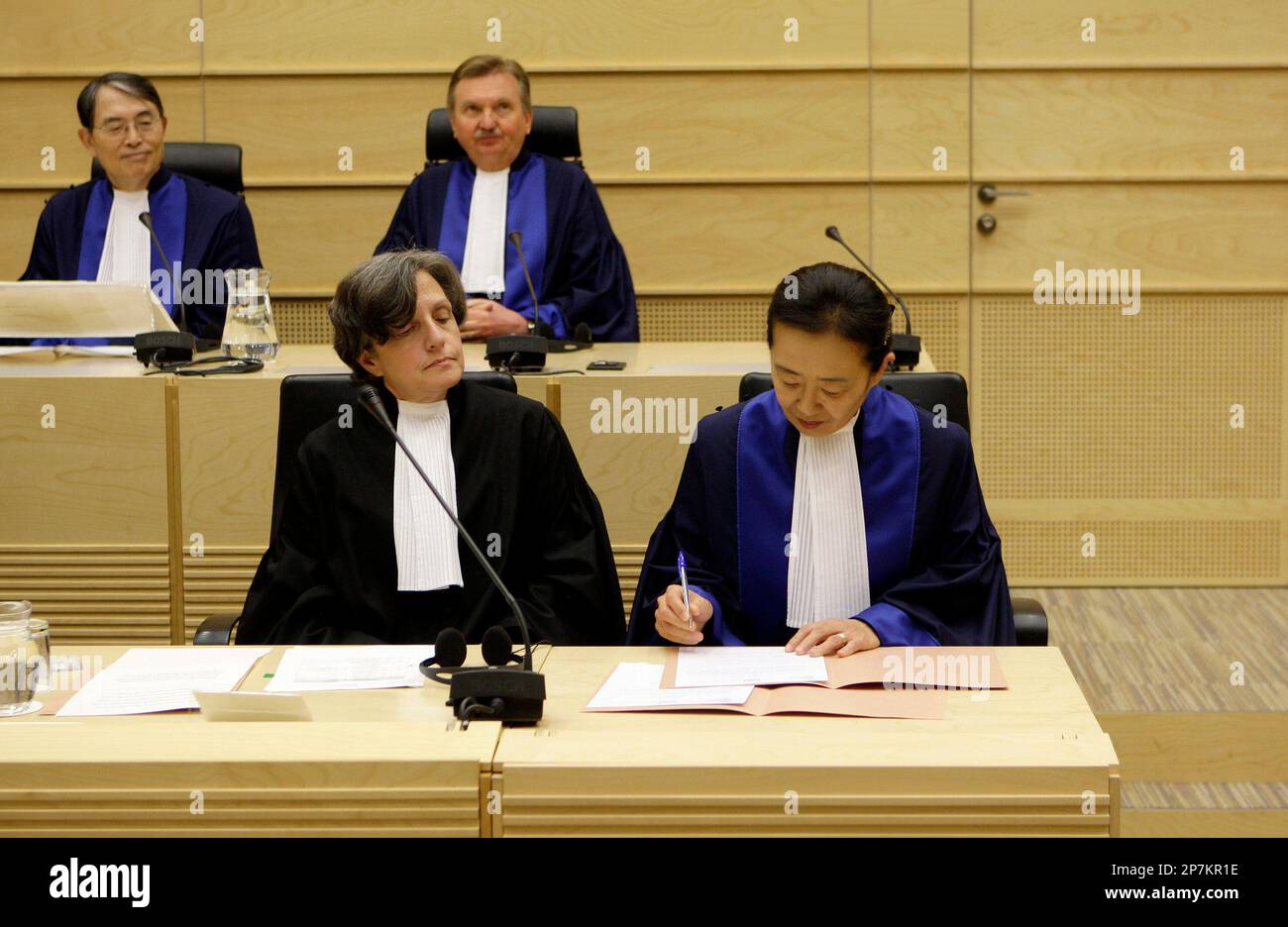Kuniko Ozaki from Japan signs during a swearing-in ceremony as a new ...