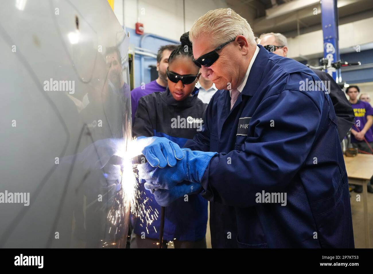 Ontario Premier Doug Ford, right, gets help from grade 11 student ...
