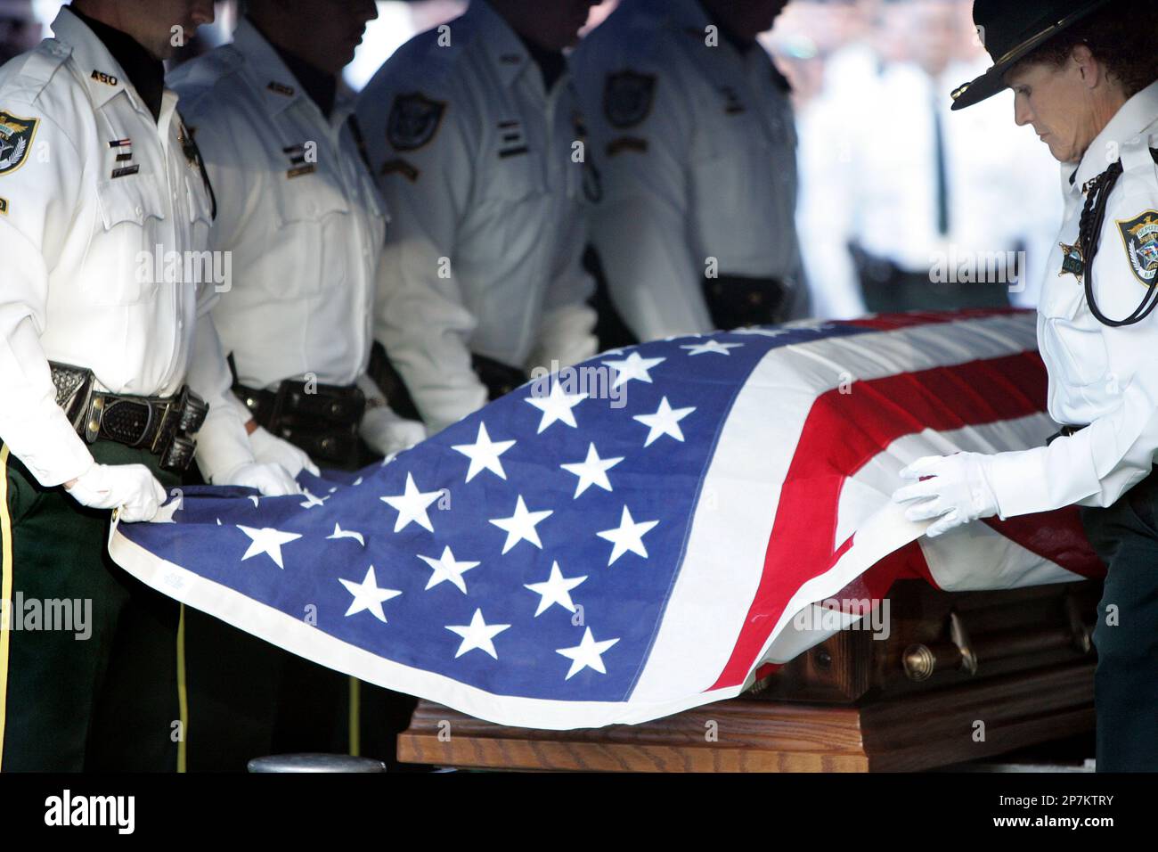Members of the Alachua Sheriff's Office prepare to fold the American ...