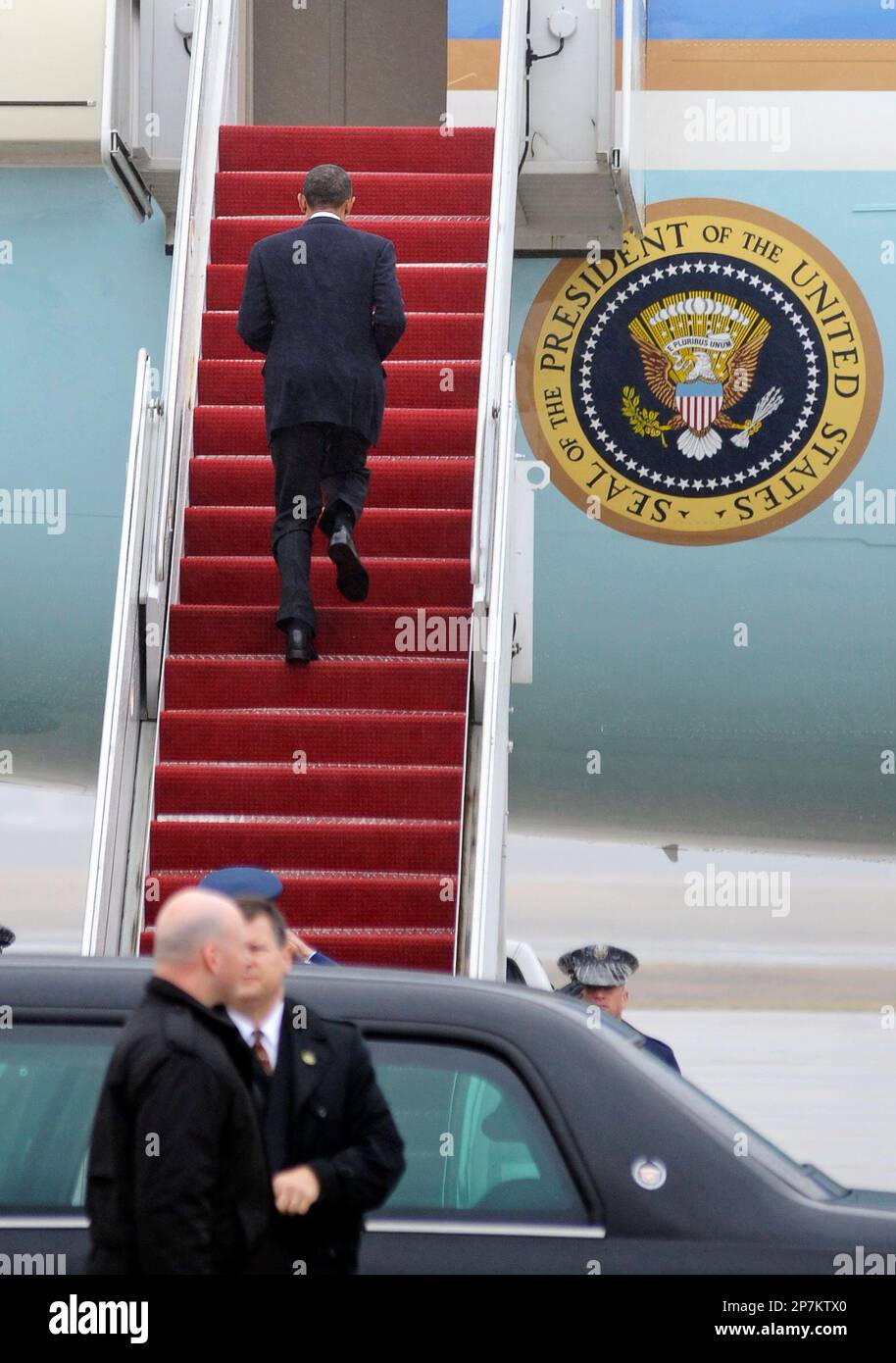 President Barack Obama runs up the stairs of Air Force One at Andrews ...