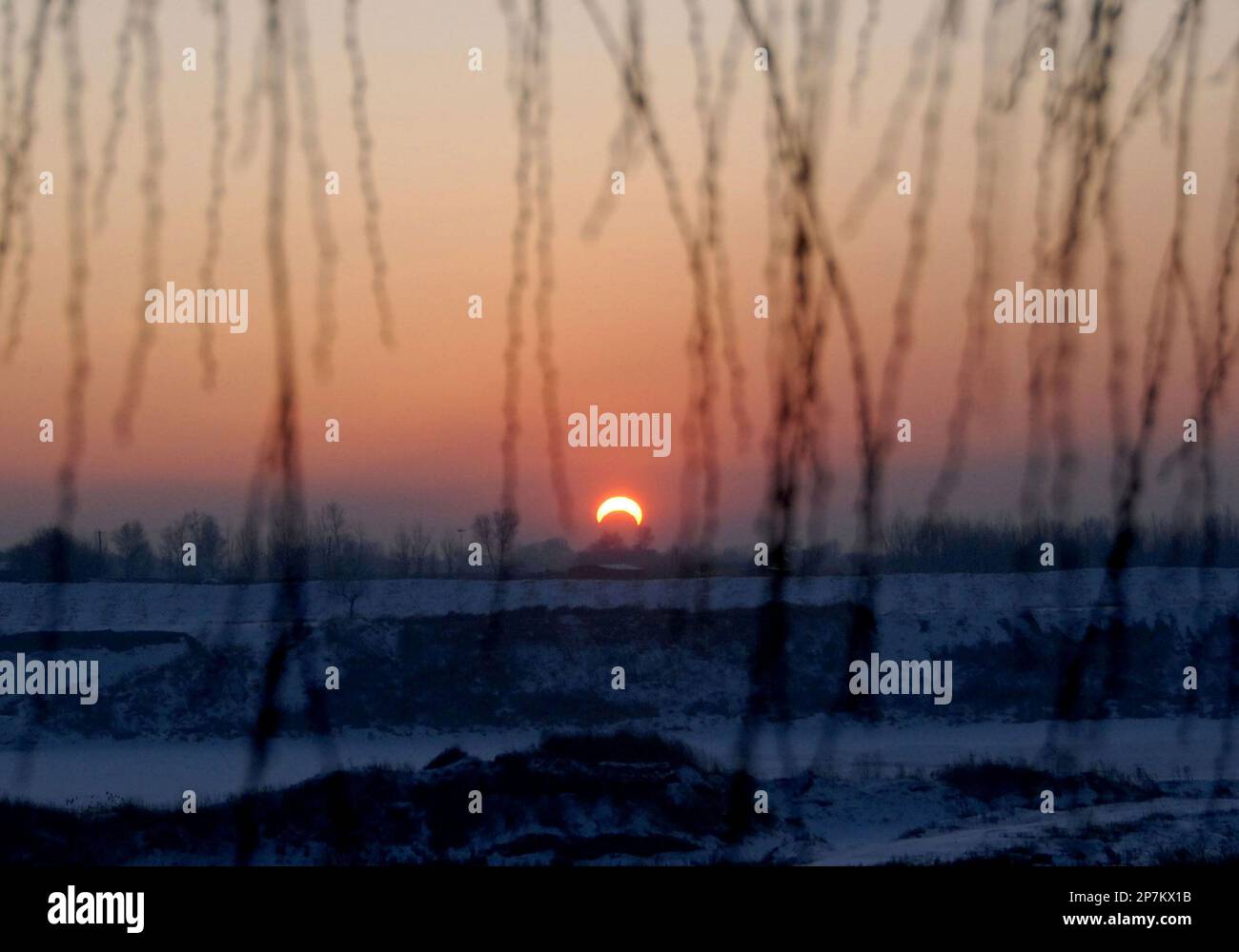The solar eclipse is seen in Shenyang in northeast China's Liaoning ...