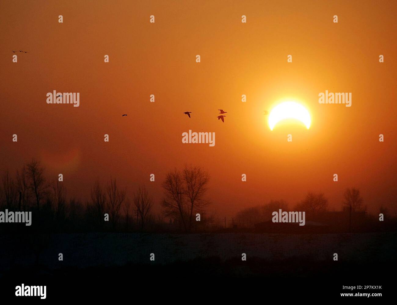 The solar eclipse is seen in Shenyang in northeast China's Liaoning ...