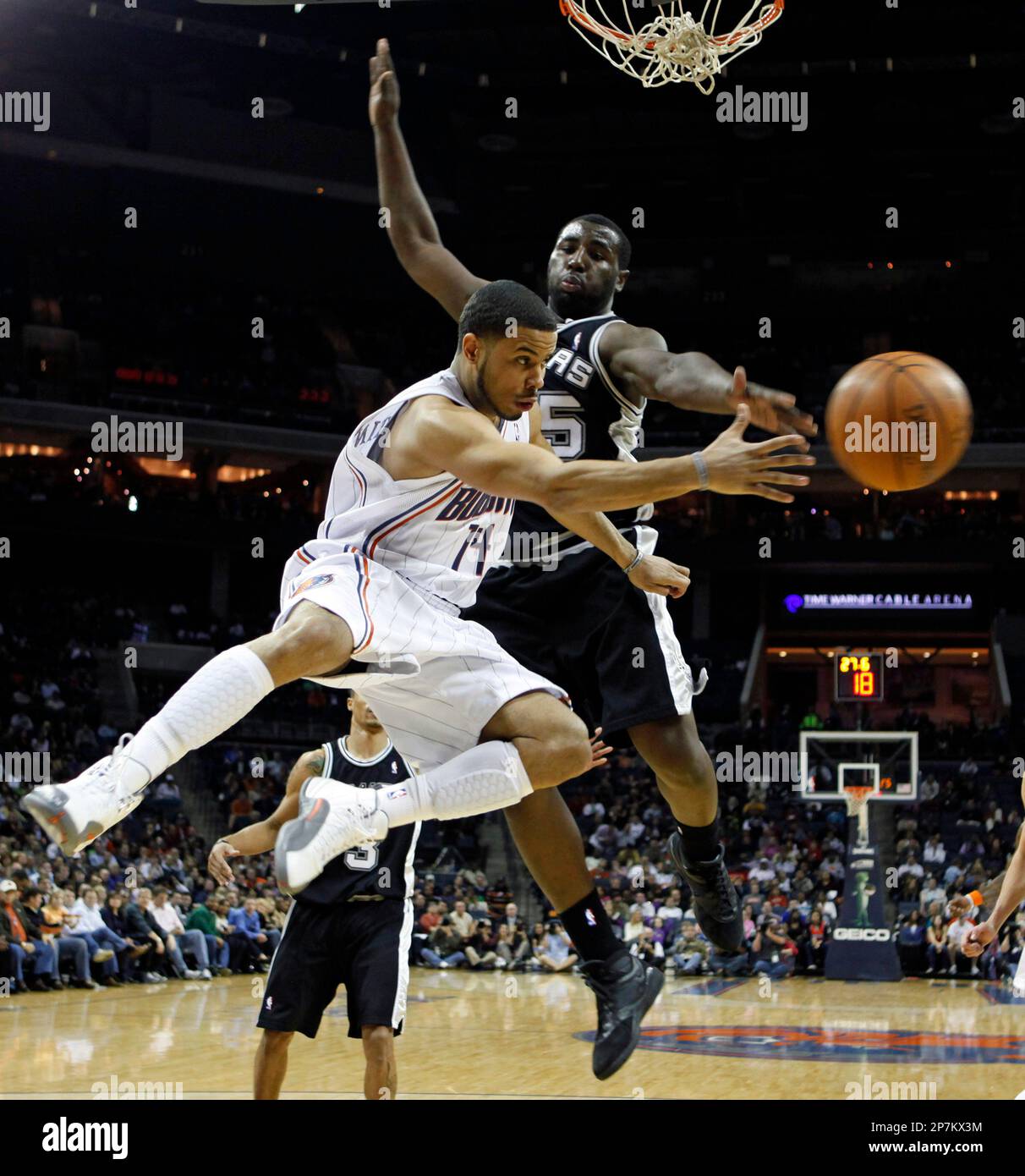 Charlotte Bobcats' D.J. Augustin (14) passes the ball around San ... Charlotte Bobcats' D.J. Augustin (14) passes the ball around San ...