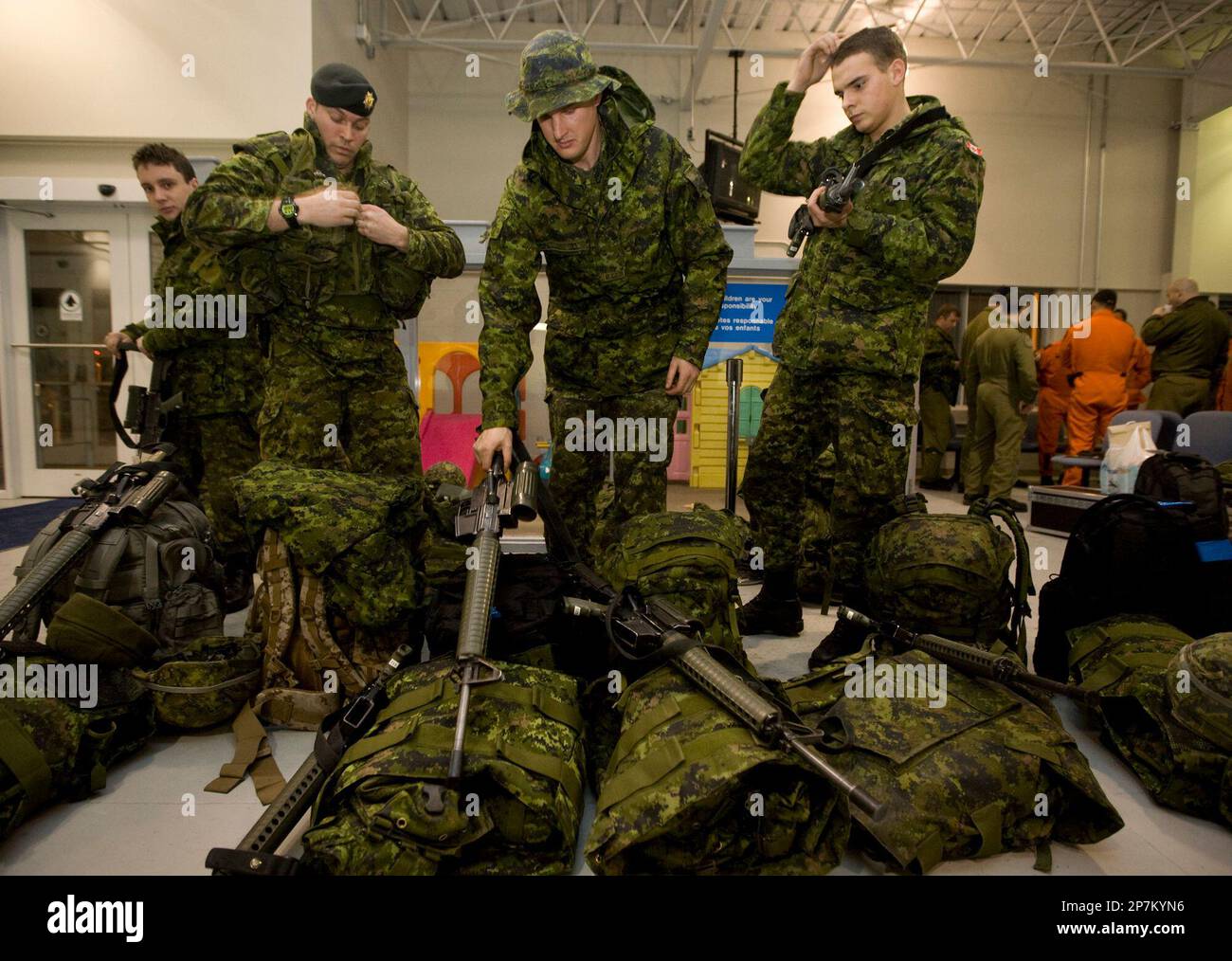 Military personnel in Trenton, Ontario, prepare to leave on a Disaster ...
