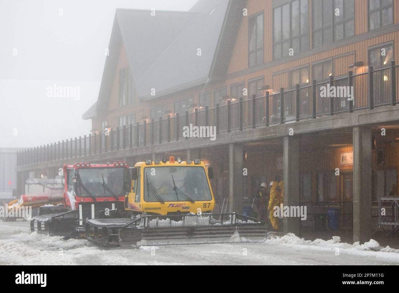 Snow grooming machines sit idle outside the main lodge at Cypress ...