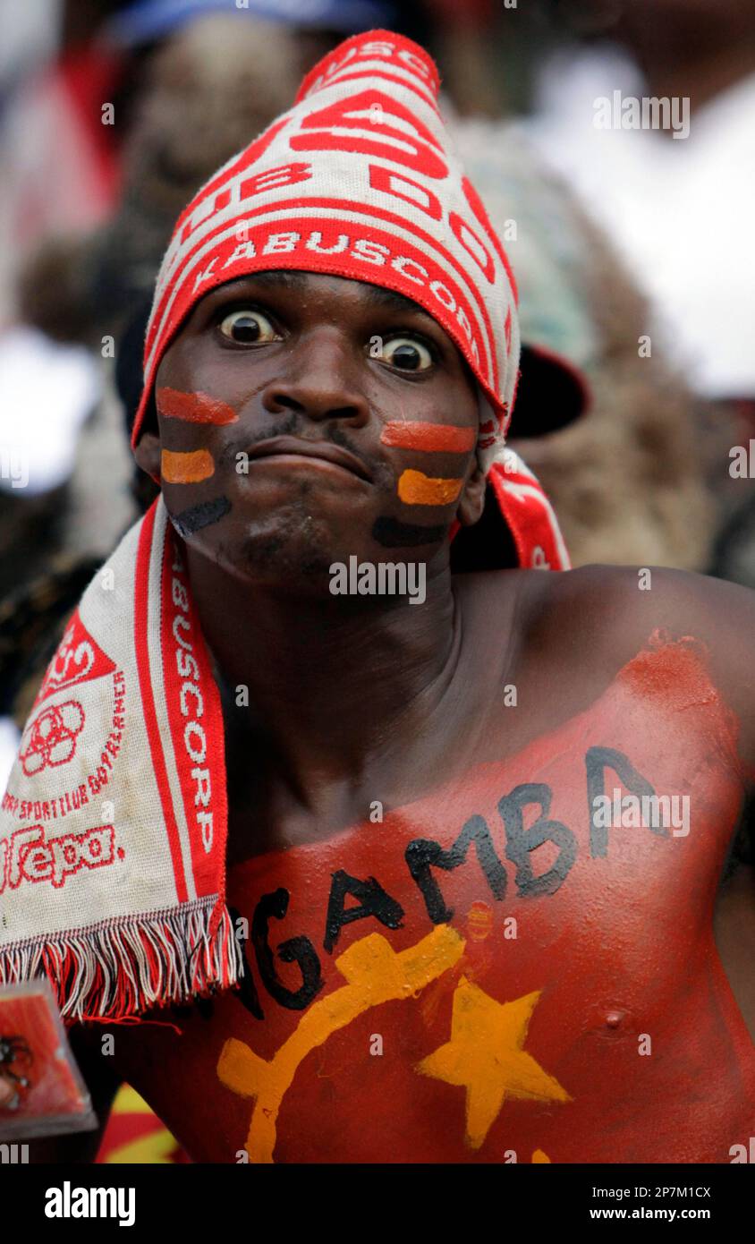 An Angolan fan wears body paint as he watches the opening ceremony of ...