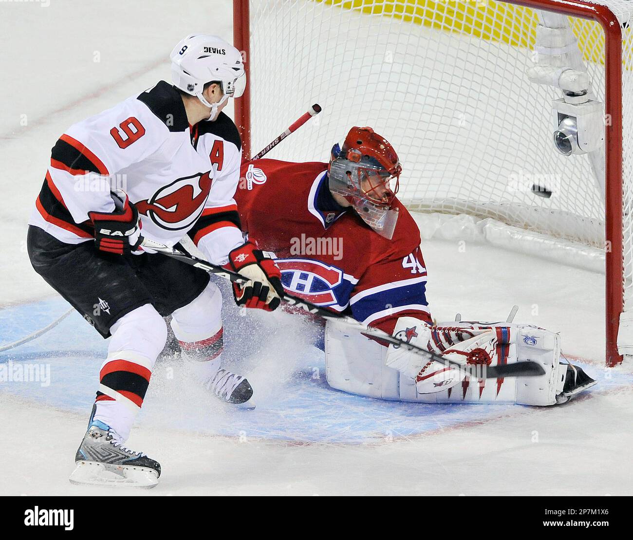 New Jersey Devils' Zach Parise, left, scores the winning goal on ...