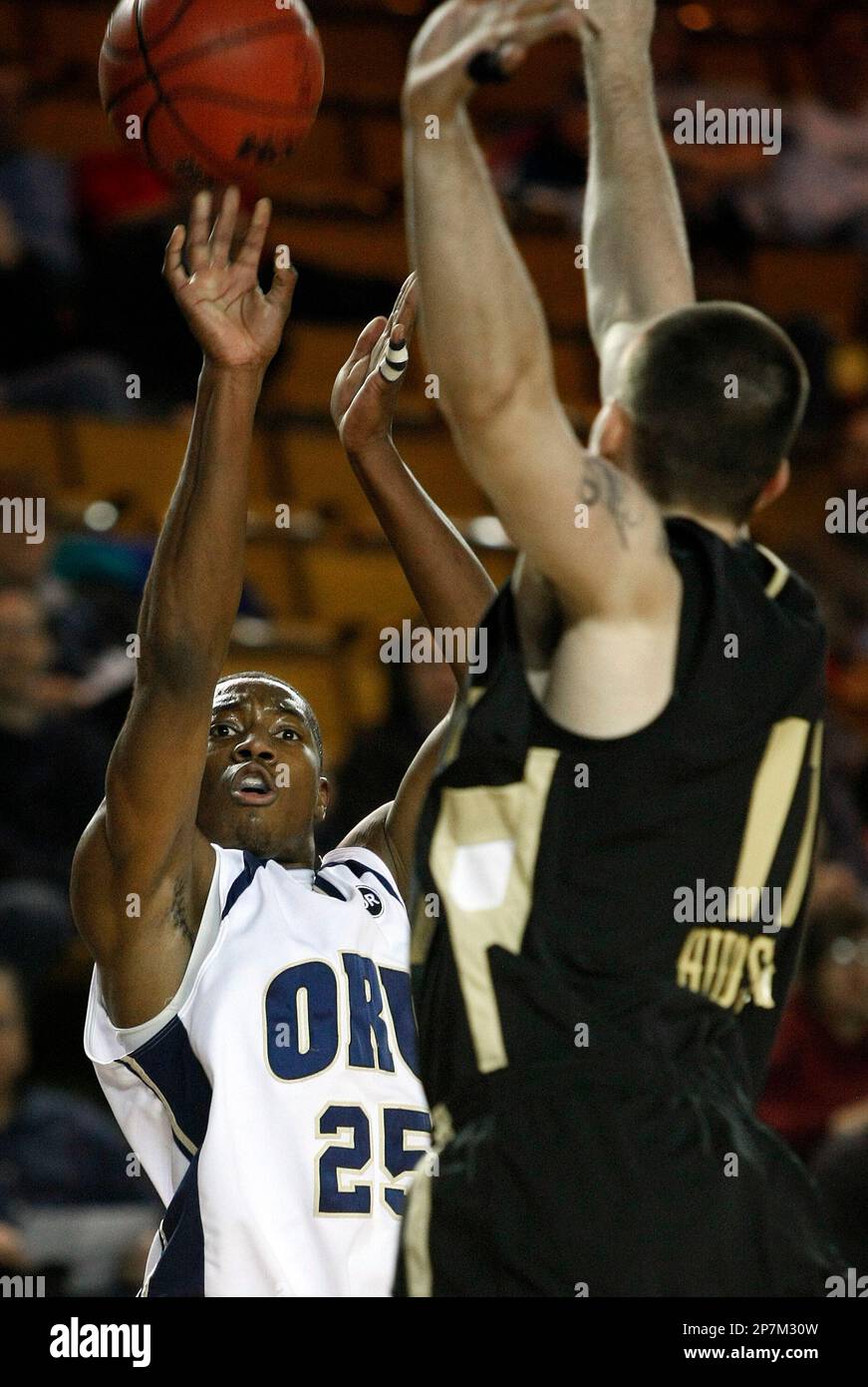 Oral Roberts' Kyron Stokes fires a 3-pointer over Oakland, Mich.'s Will ...