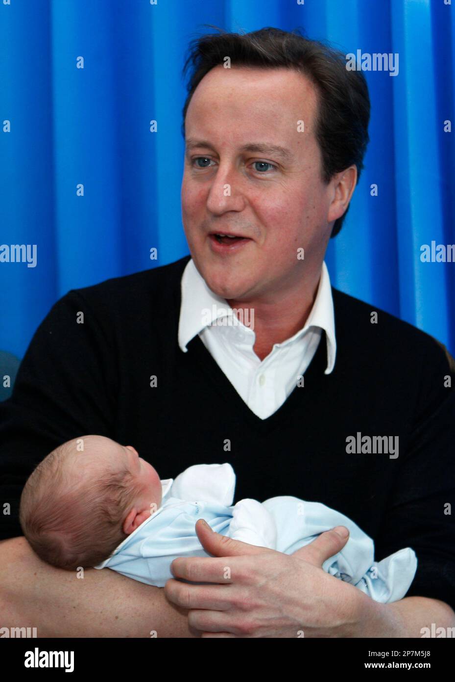 Britain's Conservative Party Leader, David Cameron holds three days old ...
