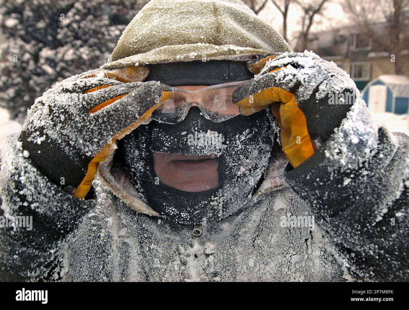 Chris Kraft is seen in his blizzard attire and out clearing snow from ...