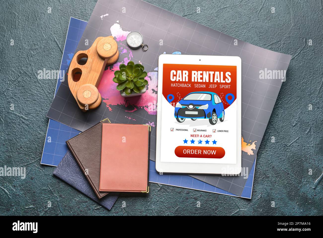 Tablet computer with open page of car rental website, maps and ...