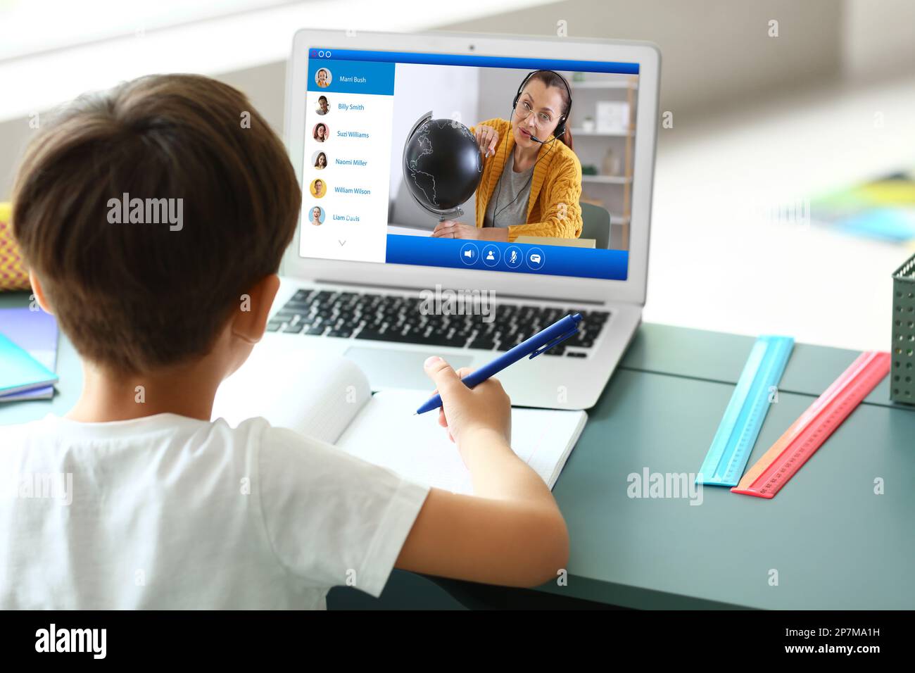 Little boy studying online at home Stock Photo - Alamy