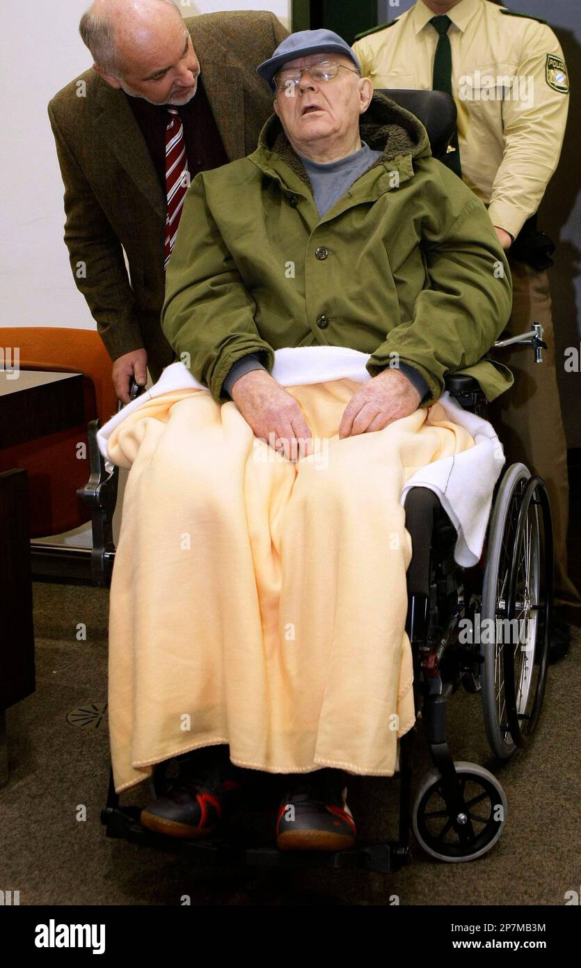 Accused Nazi death camp guard John Demjanjuk sits in a wheelchair while ...