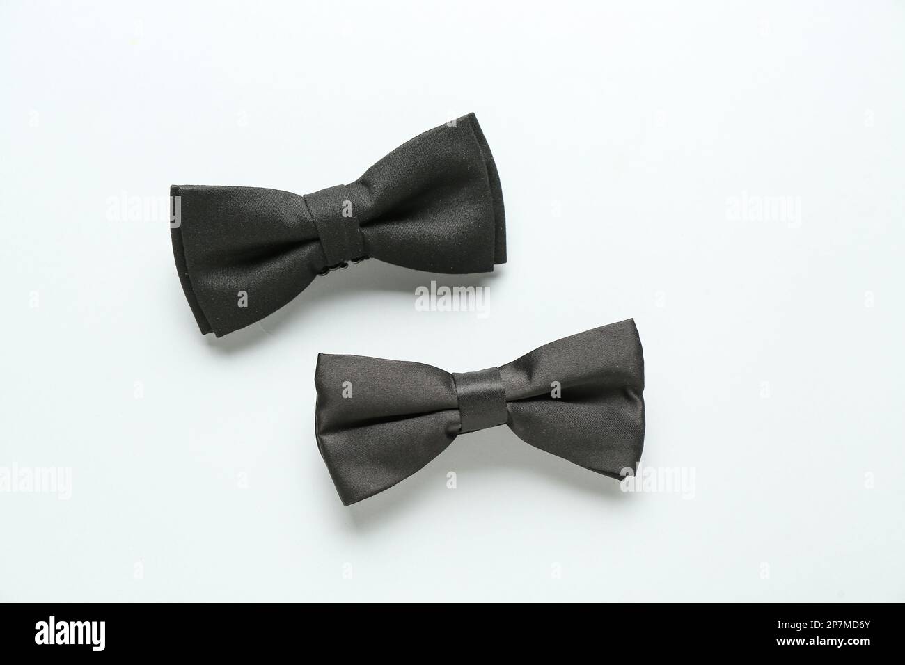 Black bow ties on white background Stock Photo - Alamy