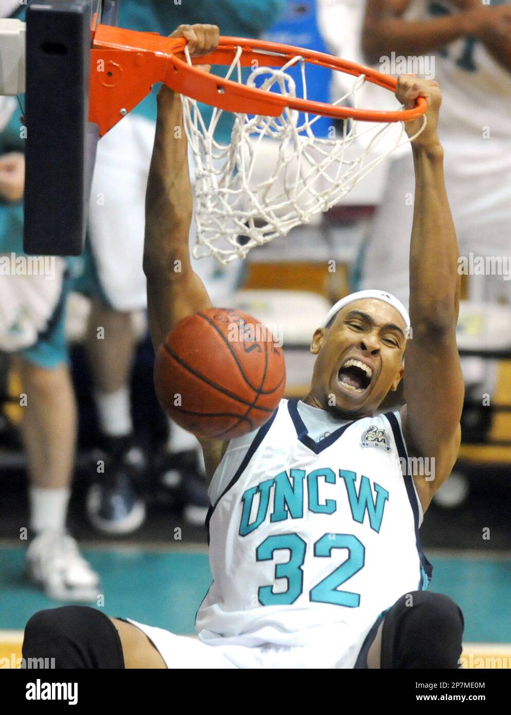 UNC Wilmington's John Fields hangs on the rim after dunking against ...