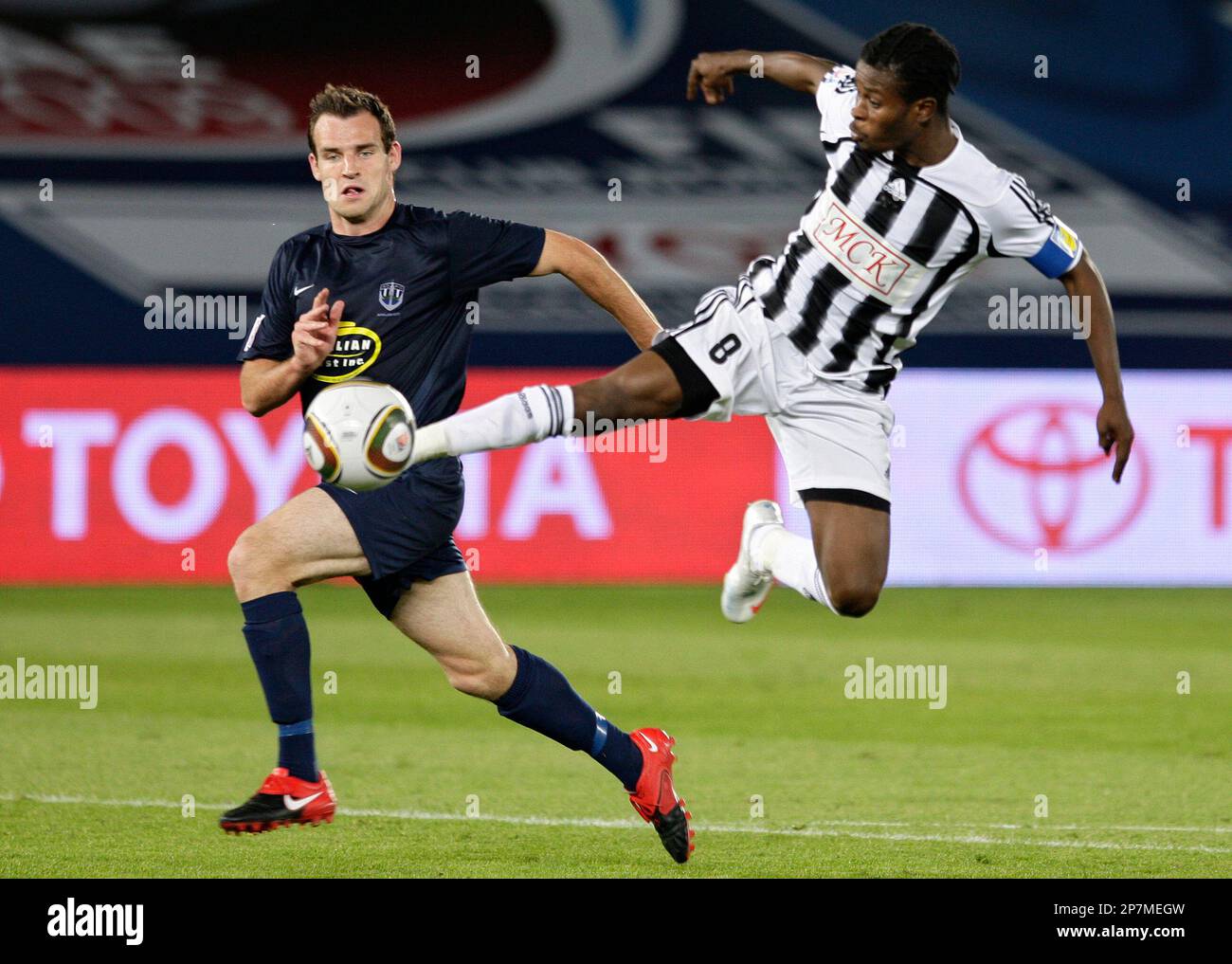 Mabi Mpute of TP Mazembe, right, kicks the ball as Auckland City's Sam ...