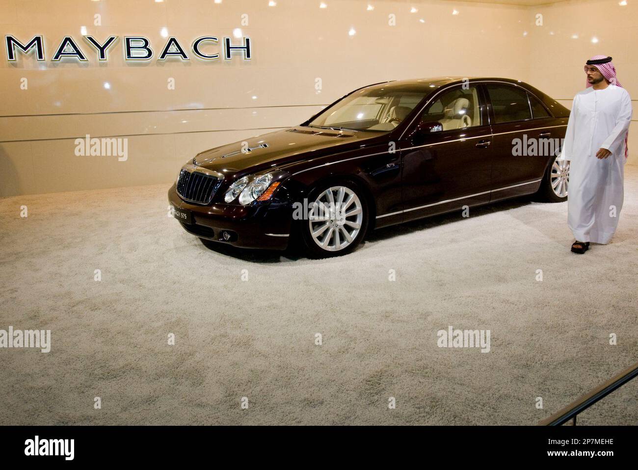 An Emirati man walks past a Maybach 575, during the Dubai International ...