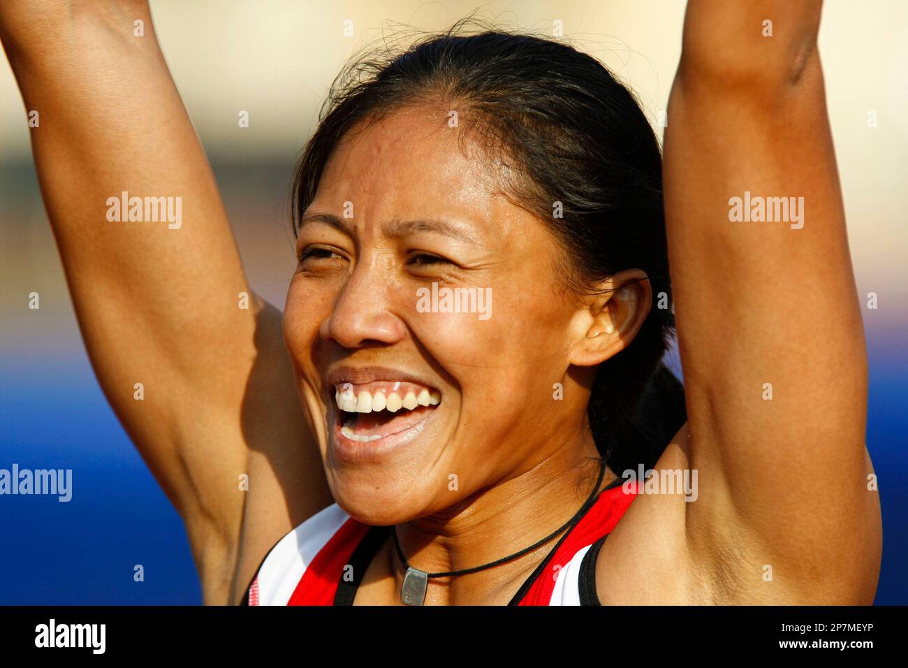 Dedeh Erawati of Indonesia competes in the 100-meter hurdles to win the ...
