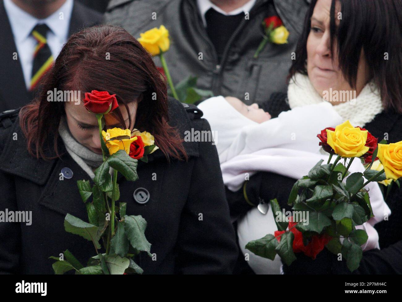Sian Goodenough, left, the fiancee of Lance Corporal Adam Drane, reacts ...