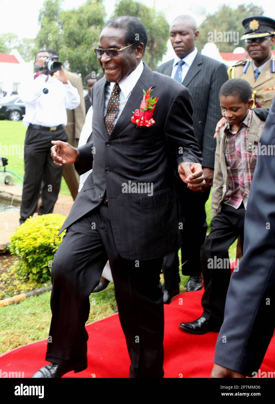 Zimbabwean President Robert Mugabe smiles as he arrives for the ...