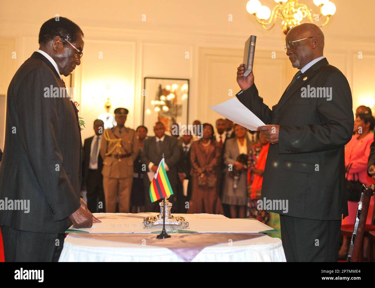 Zimbabwean President Robert Mugabe, left, swears in Zimbabwe's second ...