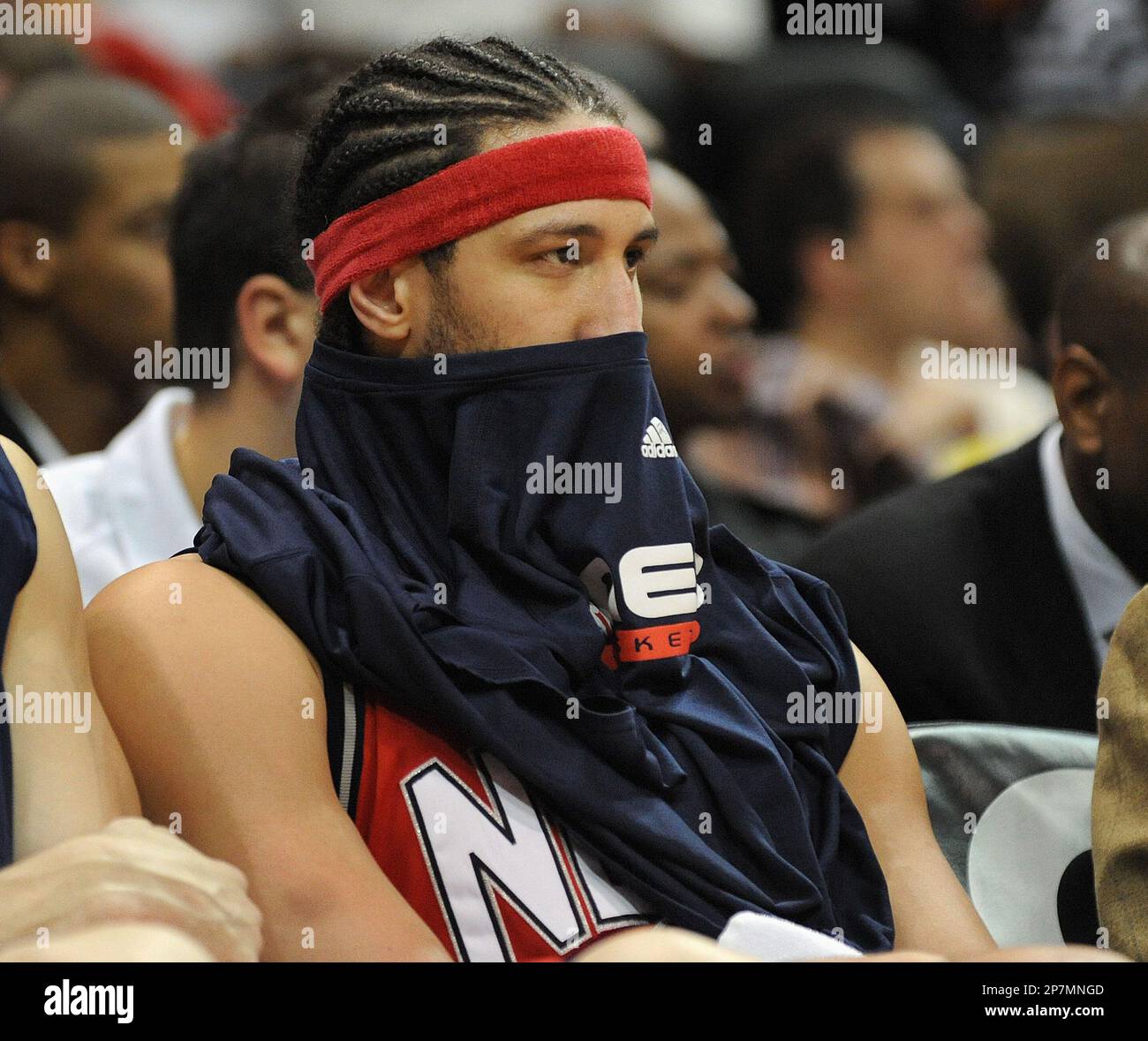 New Jersey Nets center Josh Boone covers his face while on the bench in ...