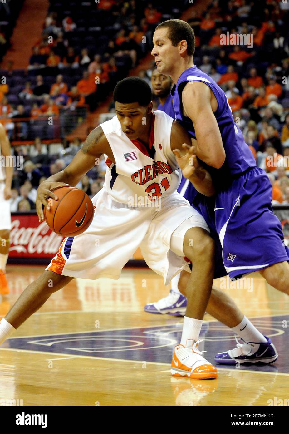 Clemson's Devin Booker (31) works against Furman's Chris Toler, right, during the second half of ...