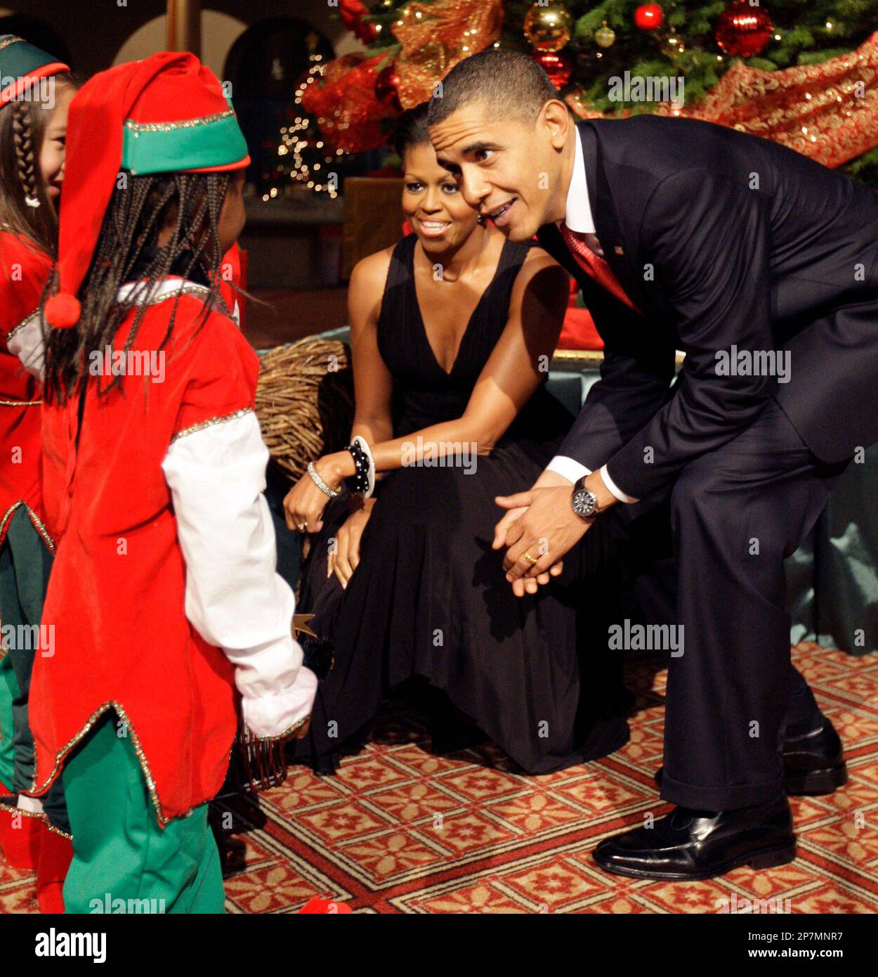 President Barack Obama and first lady Michelle Obama talk with a group ...
