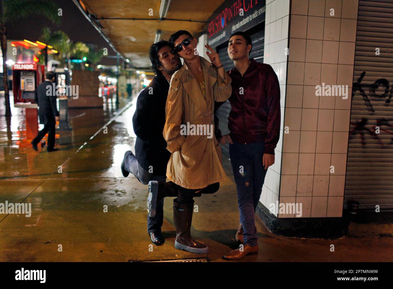 Three men pose for a picture in downtown Tijuana, northern Mexico ...
