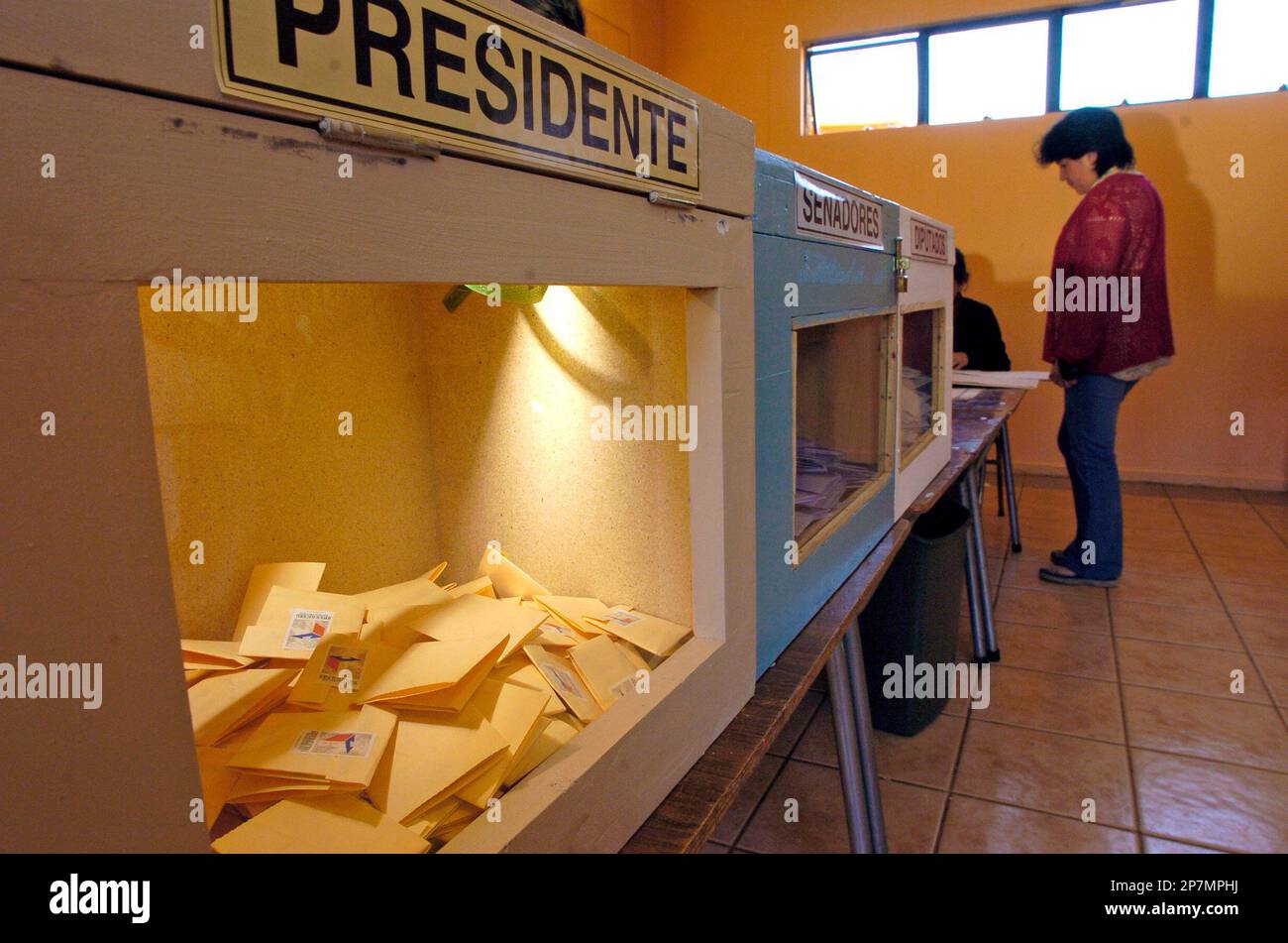 Ballots sit in a presidential election ballot box during general ...