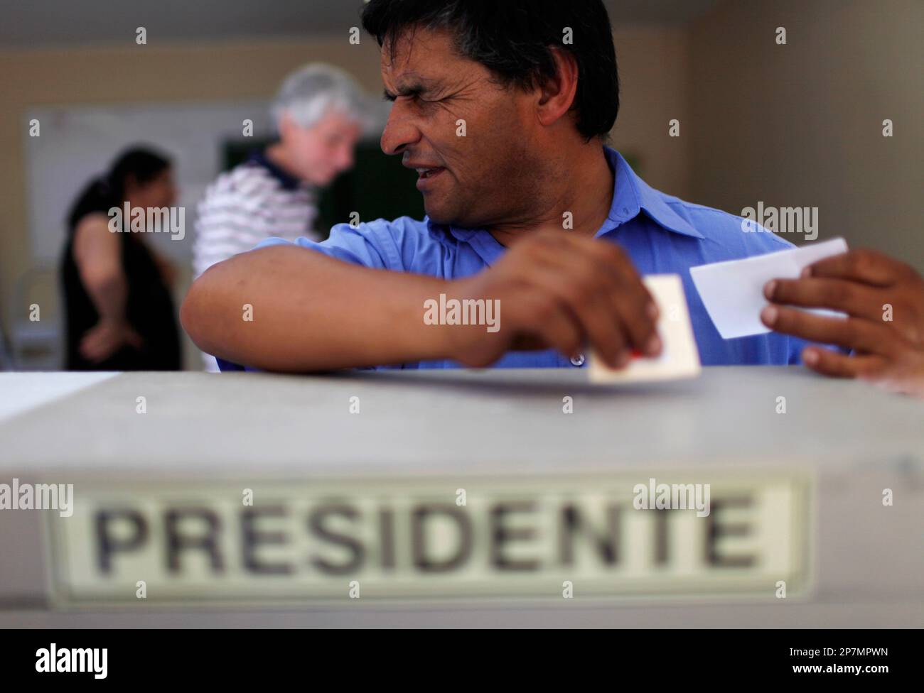 A blind voter casts his ballot in general elections in Santiago, Sunday ...